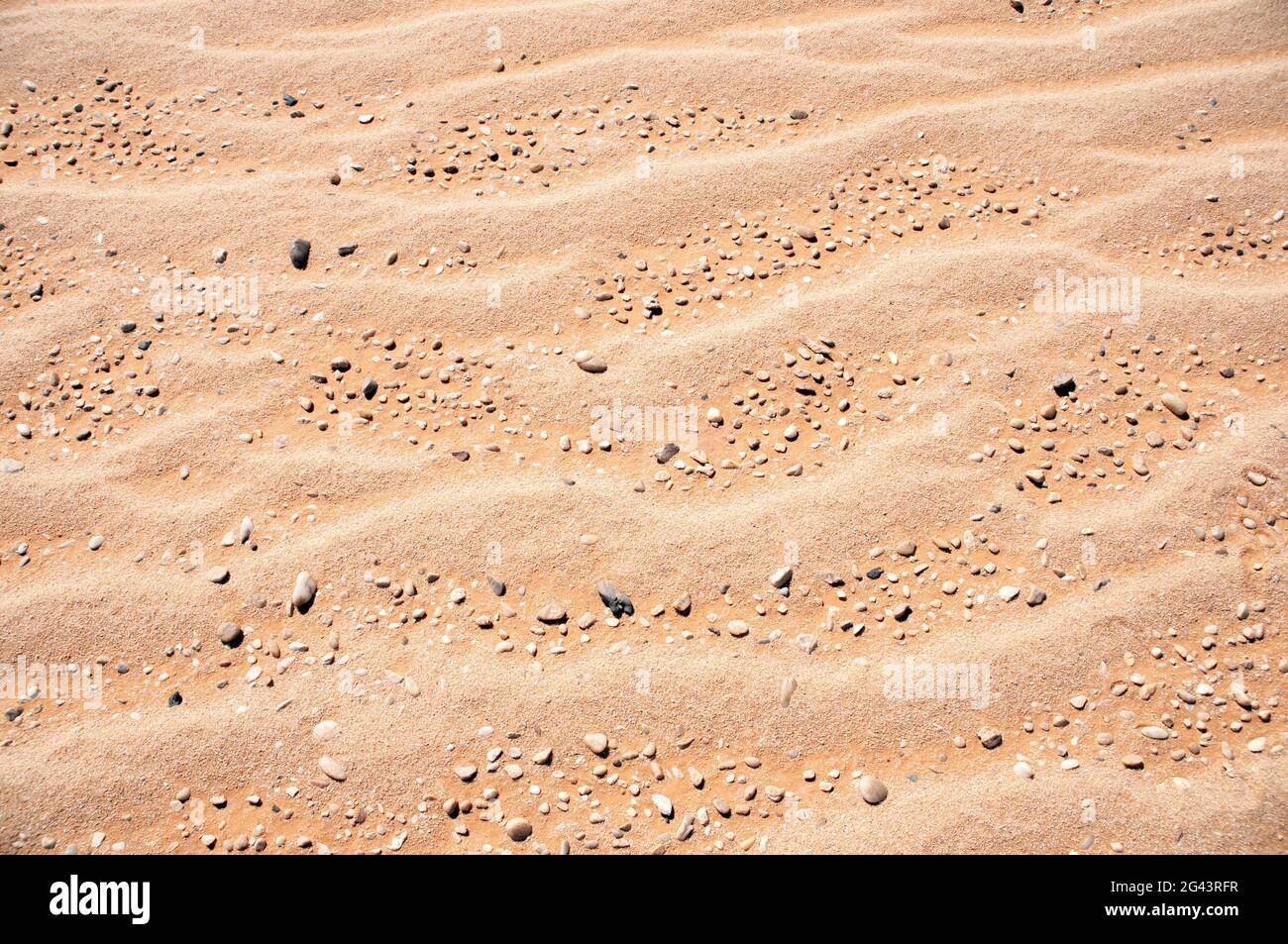 Wind-blown sand ripples and pebbles, part of an ancient seabed, in the ...