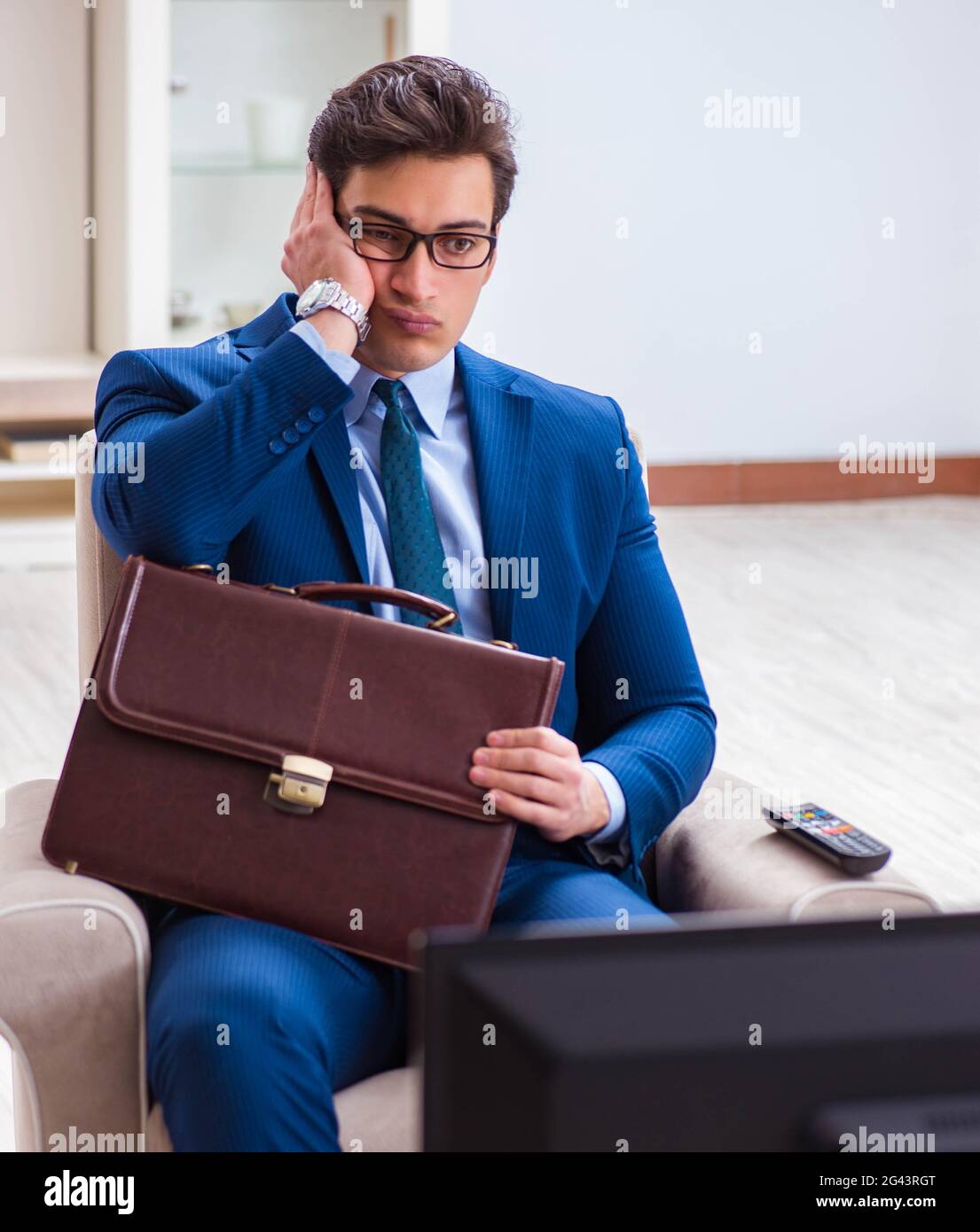 Businesman watching tv in office Stock Photo - Alamy