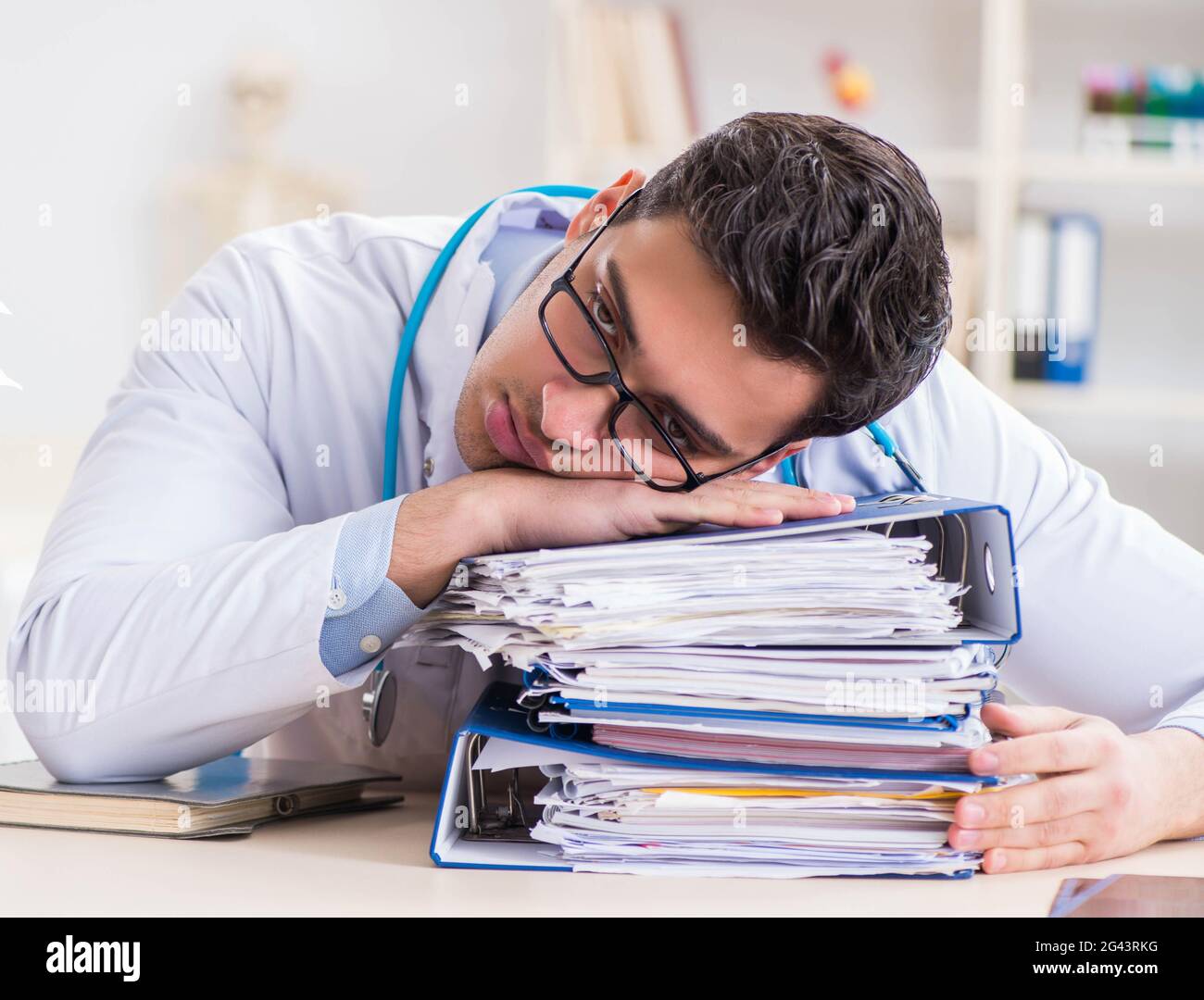 Busy doctor with too much work in hospital Stock Photo - Alamy