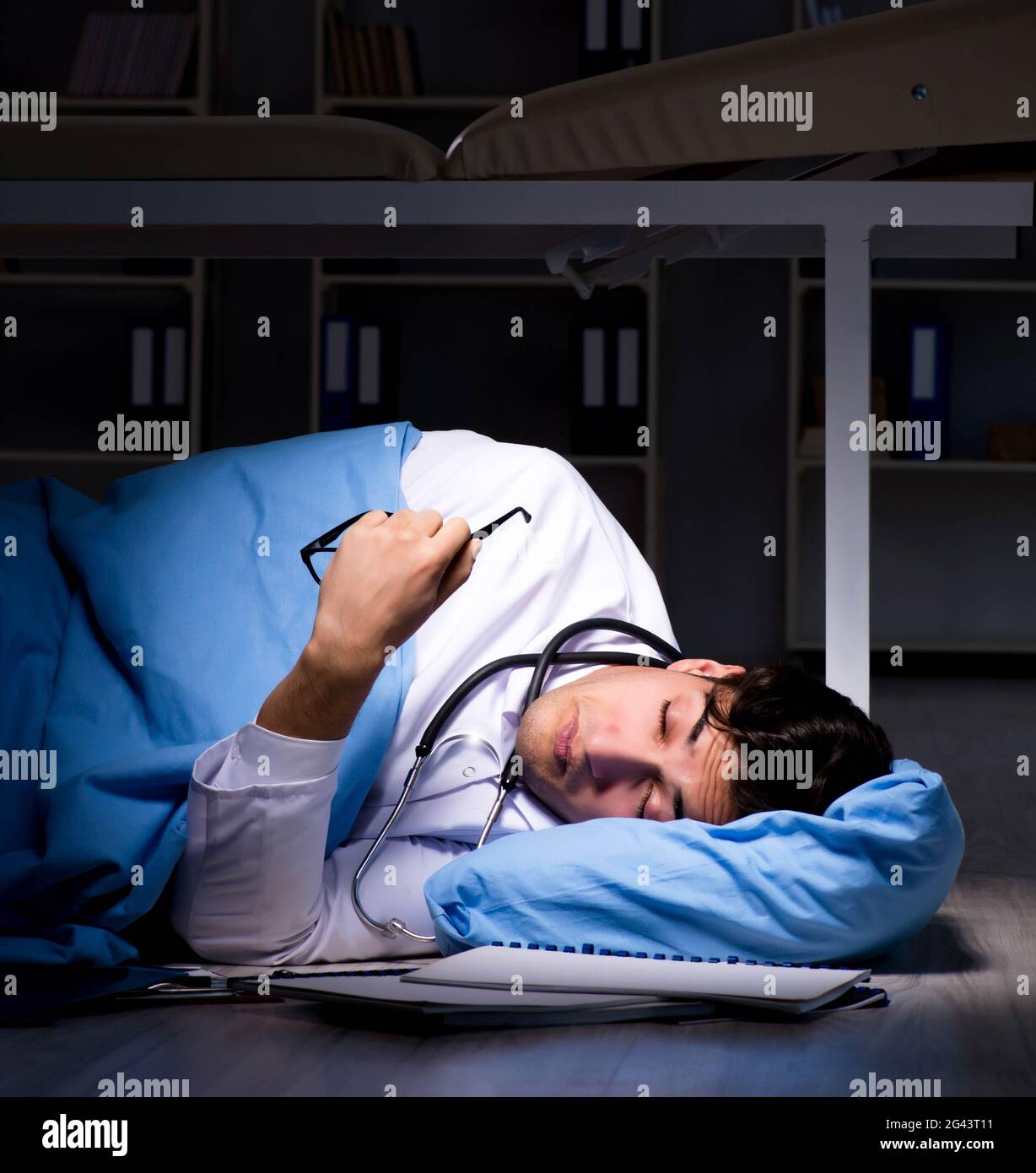 Doctor working night shift in hospital after long hours Stock Photo - Alamy