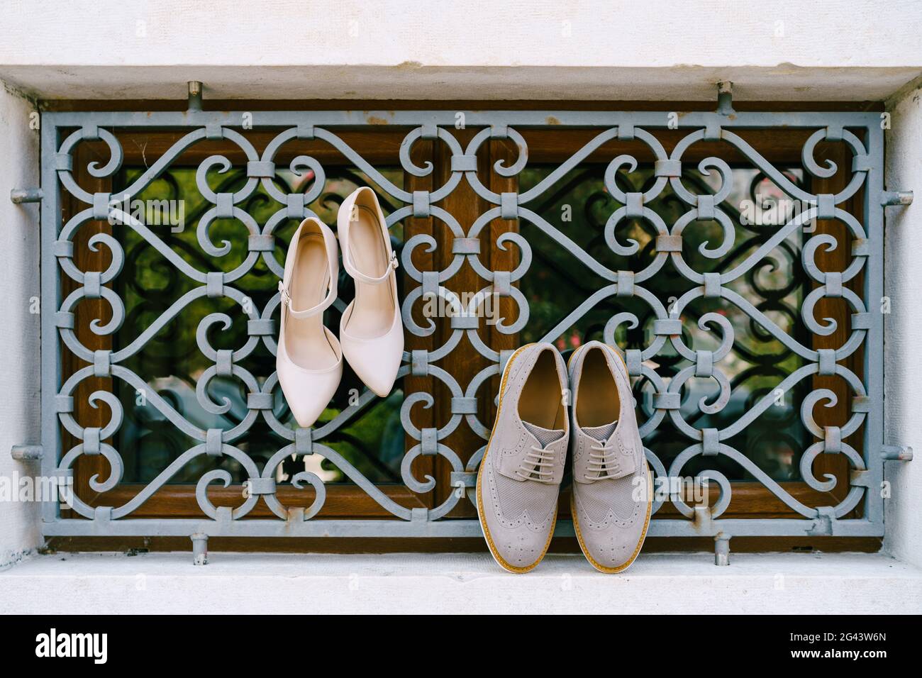 New gray men's shoes with women's white shoes on the window by the ...