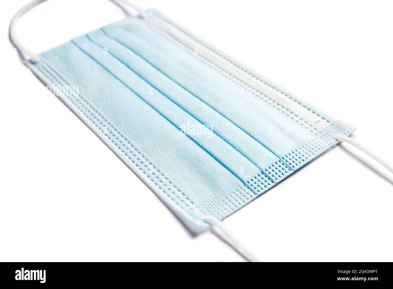 Disposable surgical mask isolated on white background Stock Photo - Alamy