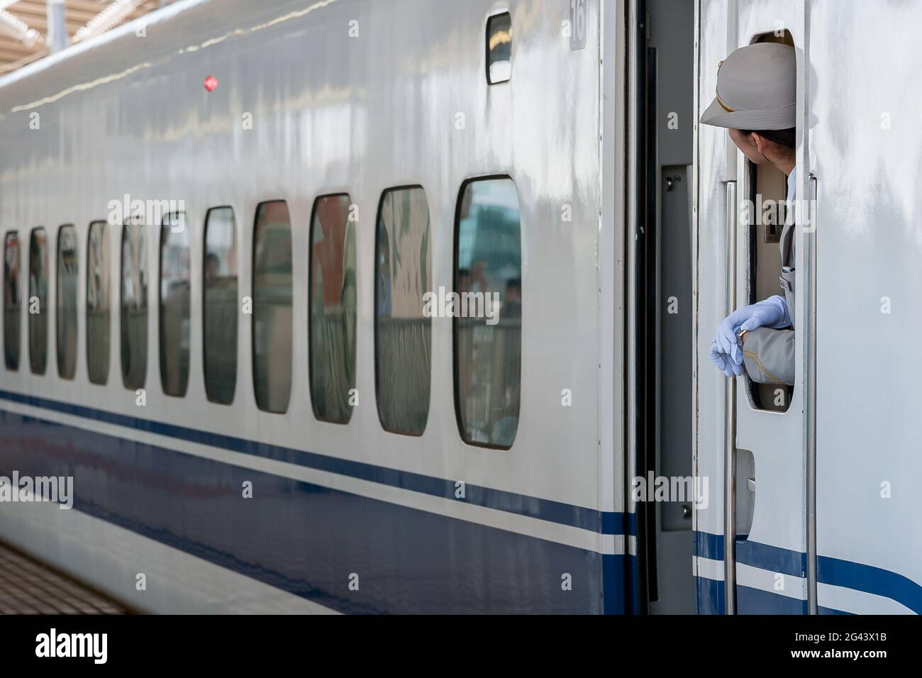 A female guard checks her watch as she looks out of the window of a 300 ...