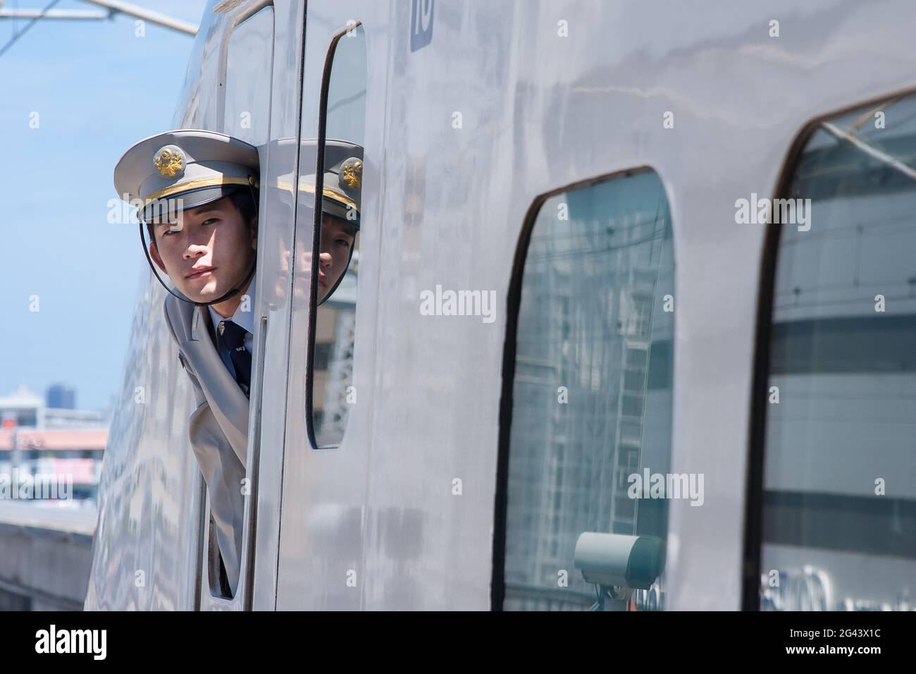 A guard looks out of the window of a 300 class shinkansen (bullet train ...