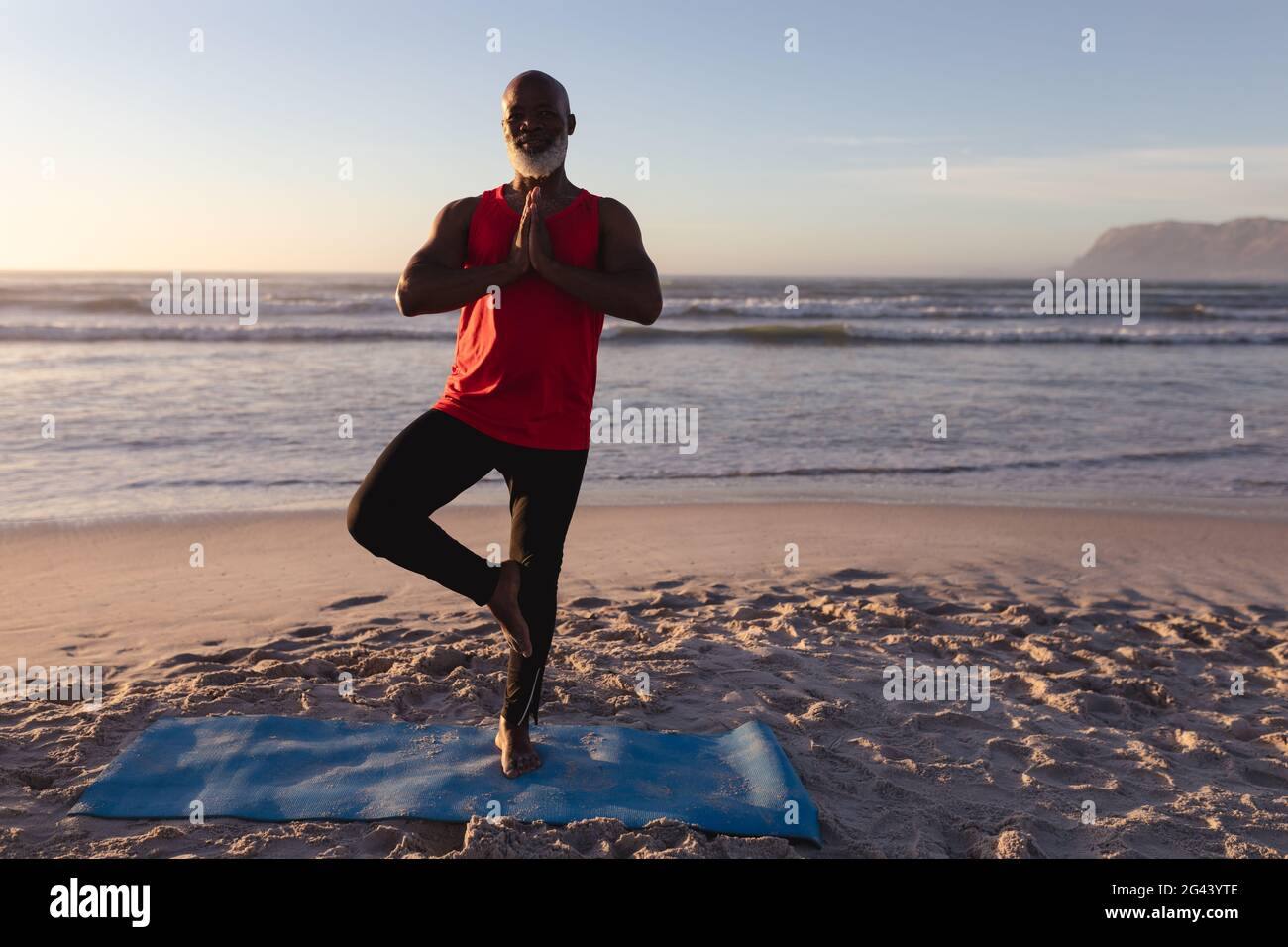 Senior african american man with folded hands meditating and practicing ...