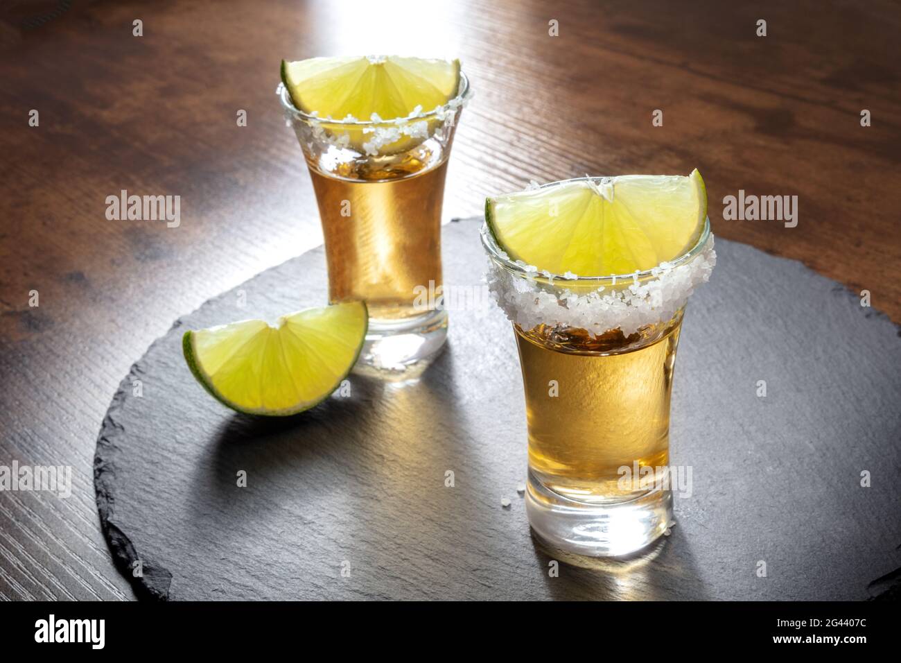 Tequila shots with salt rims and lime slices Stock Photo - Alamy