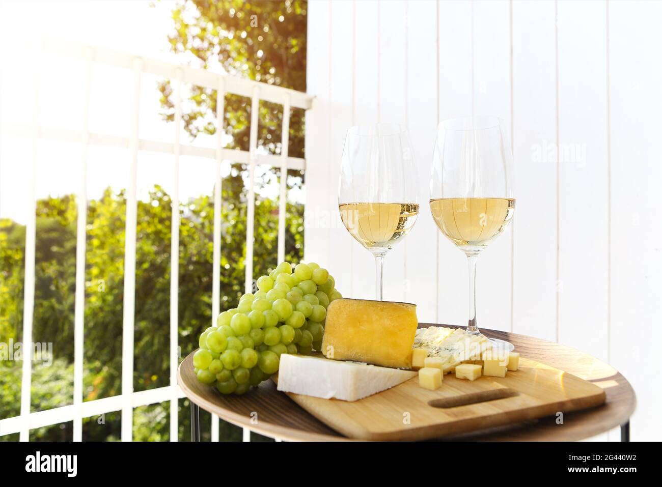 Wine with grapes and cheese on terrace Stock Photo - Alamy