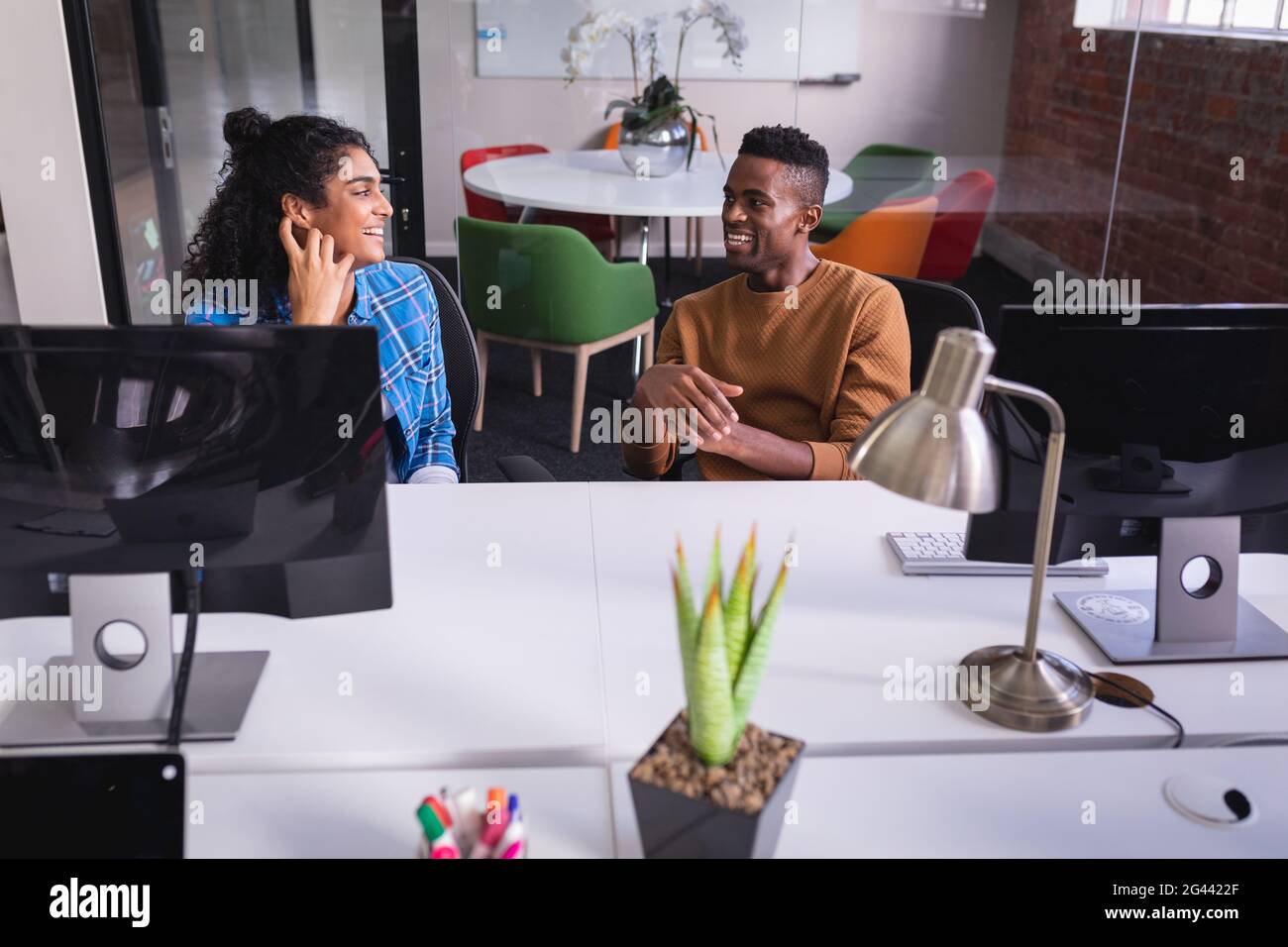 Diverse work colleagues sitting in hi-res stock photography and images ...