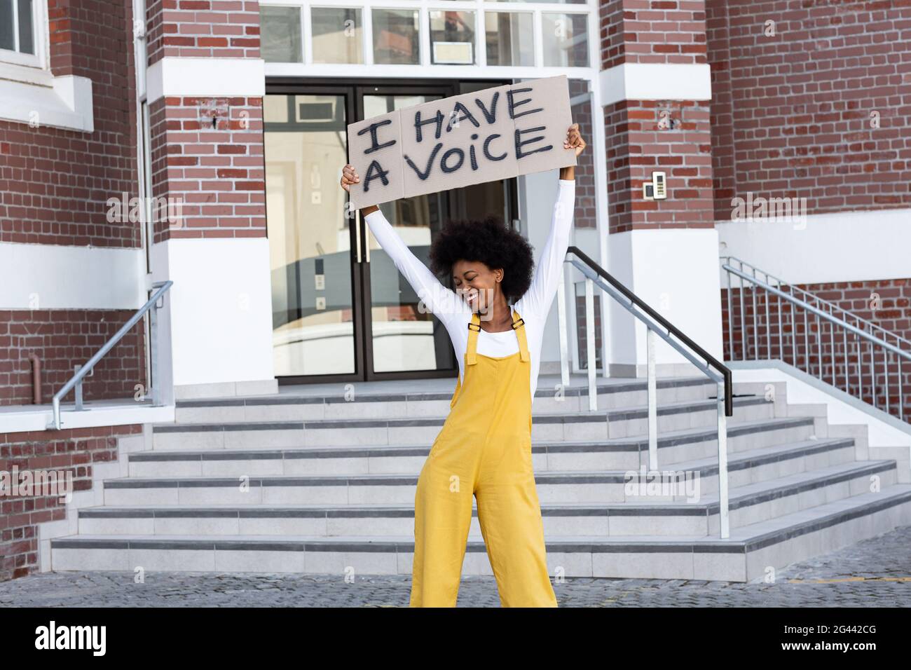 Portrait of mixed race woman holding placard Stock Photo - Alamy