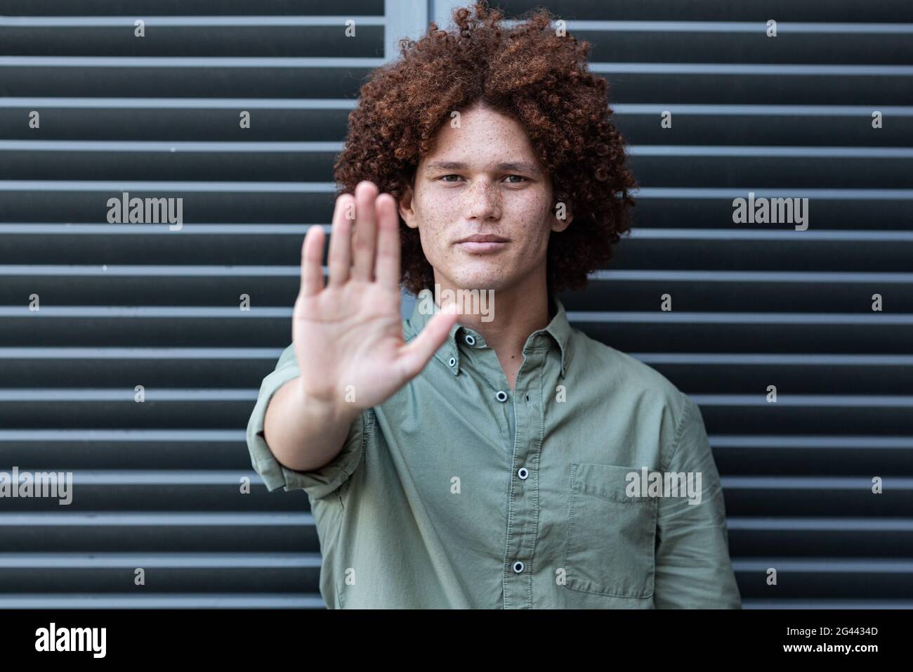 Portrait of mixed race man holding hand making a stop gesture Stock ...
