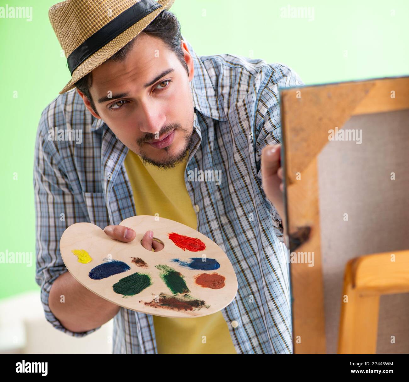 Young male artist working on new painting in his studio Stock Photo - Alamy