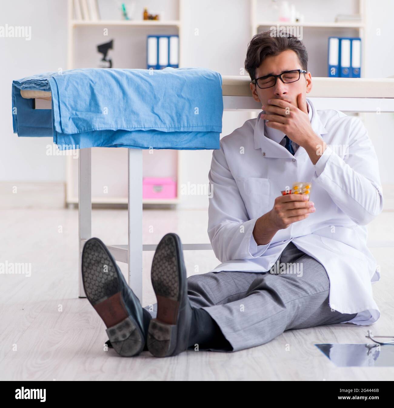Doctor sitting on the floor in hospital Stock Photo - Alamy