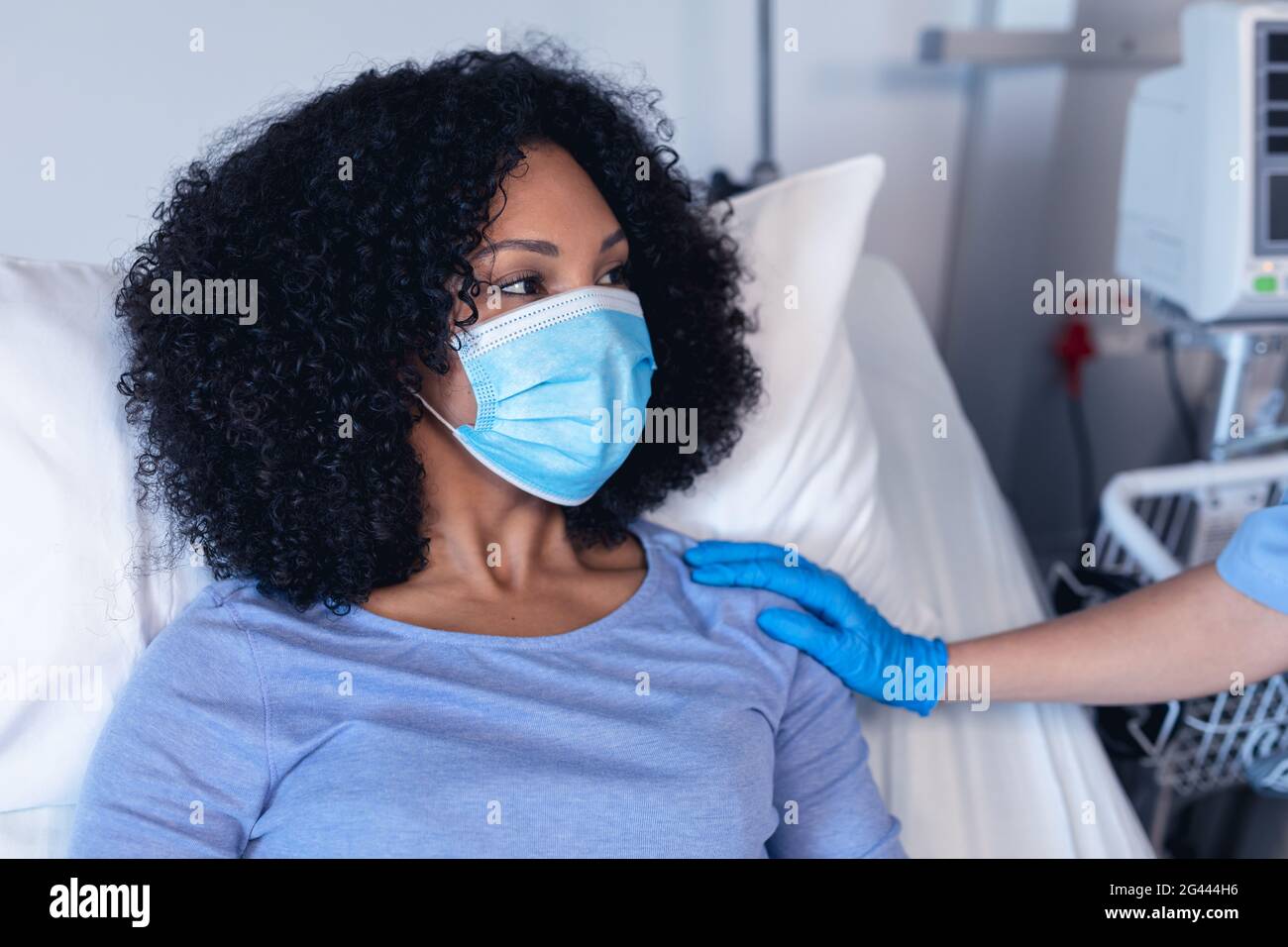 African american female patient in hospital bed wearing face mask ...