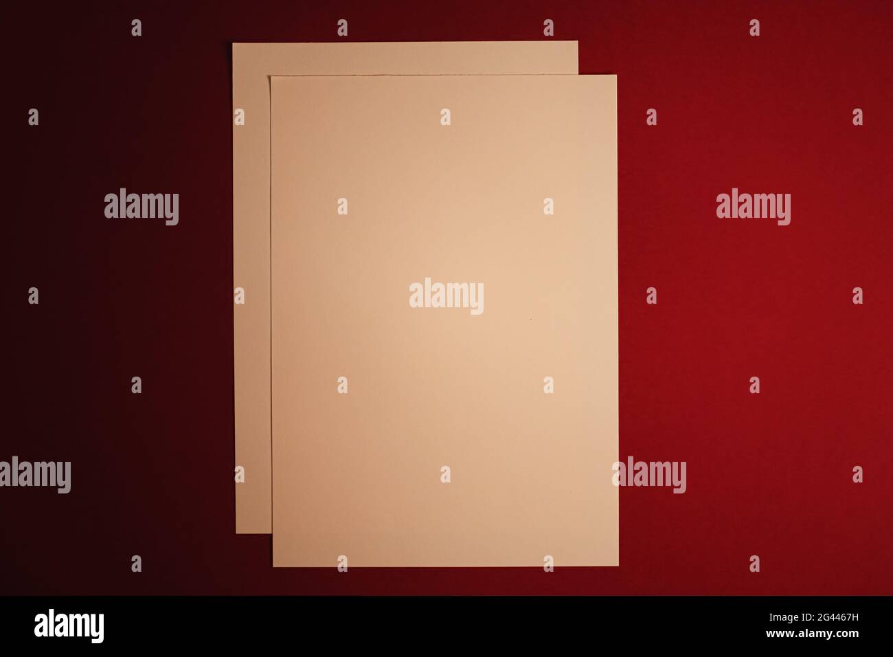 Blank A4 paper, beige on dark red background as office stationery ...