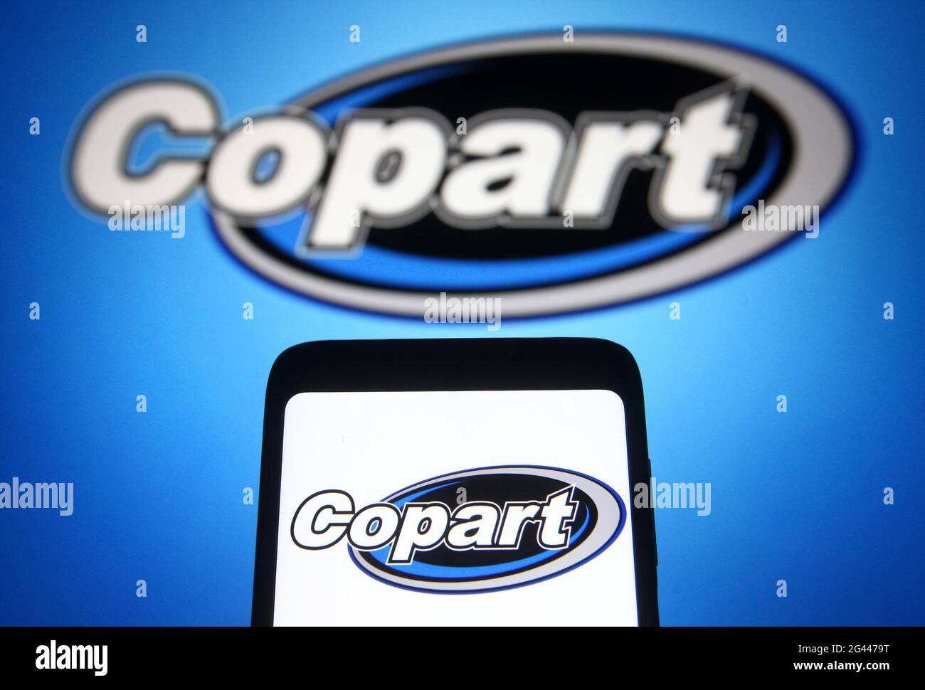In this photo illustration, Copart logo is seen on a smartphone and a ...