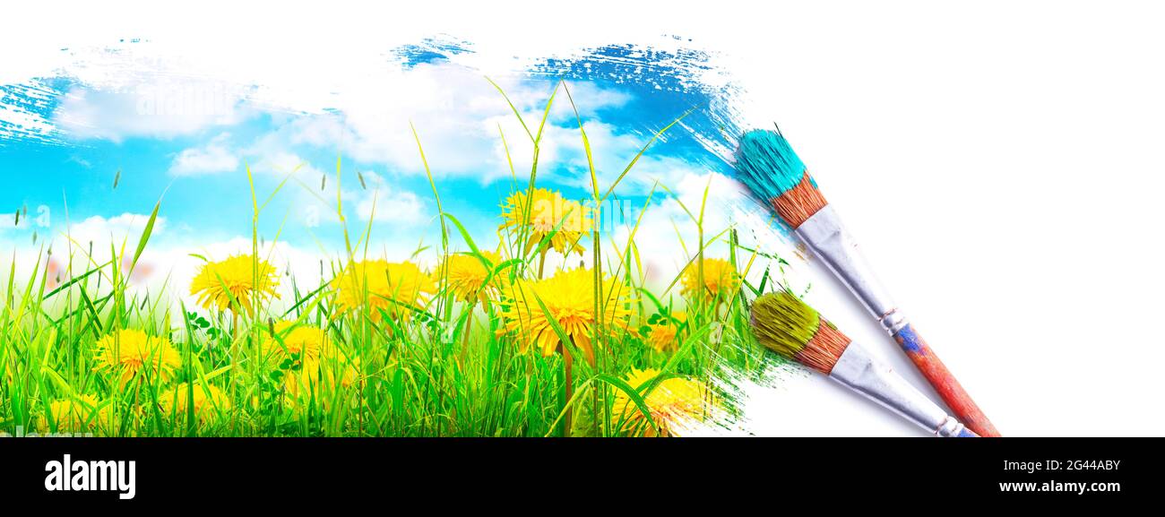 Painting the spring landscape. Brush with blue paint over sky and green ...