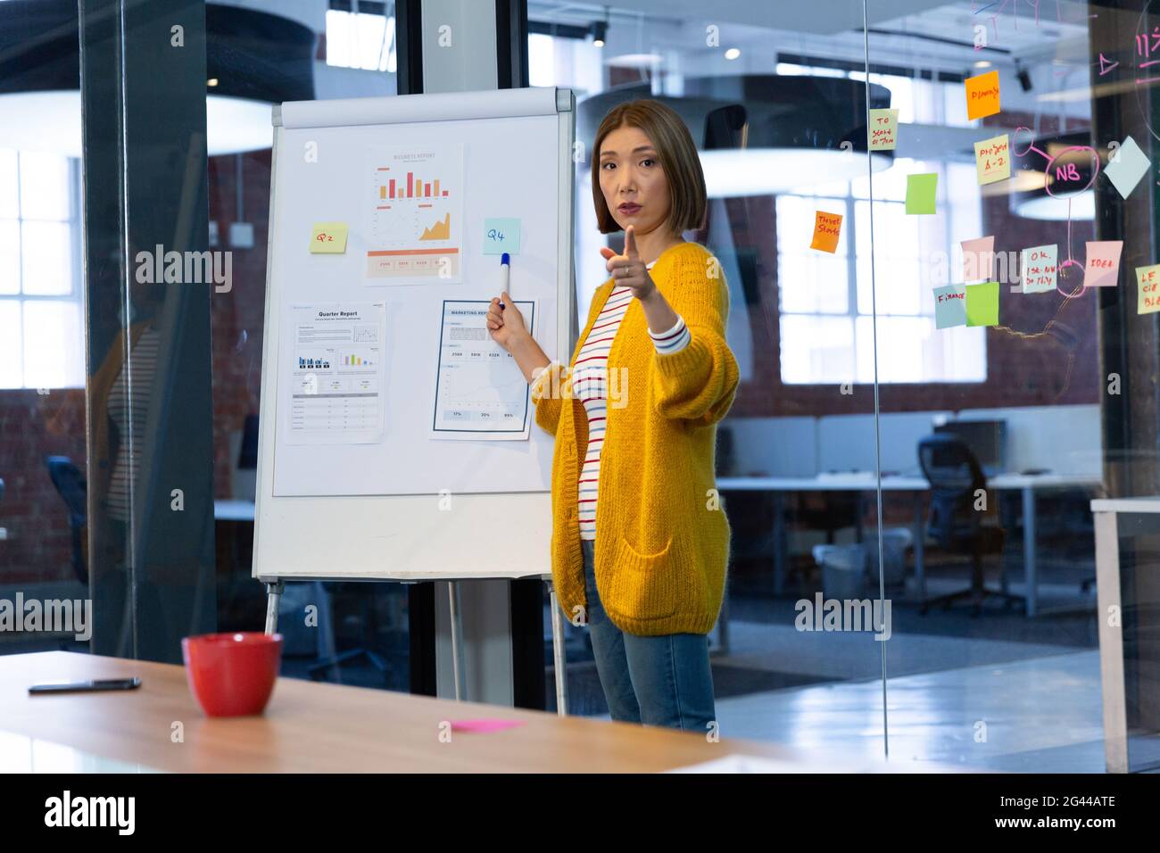 Portrait of asian businesswoman standing in front of whiteboard ...