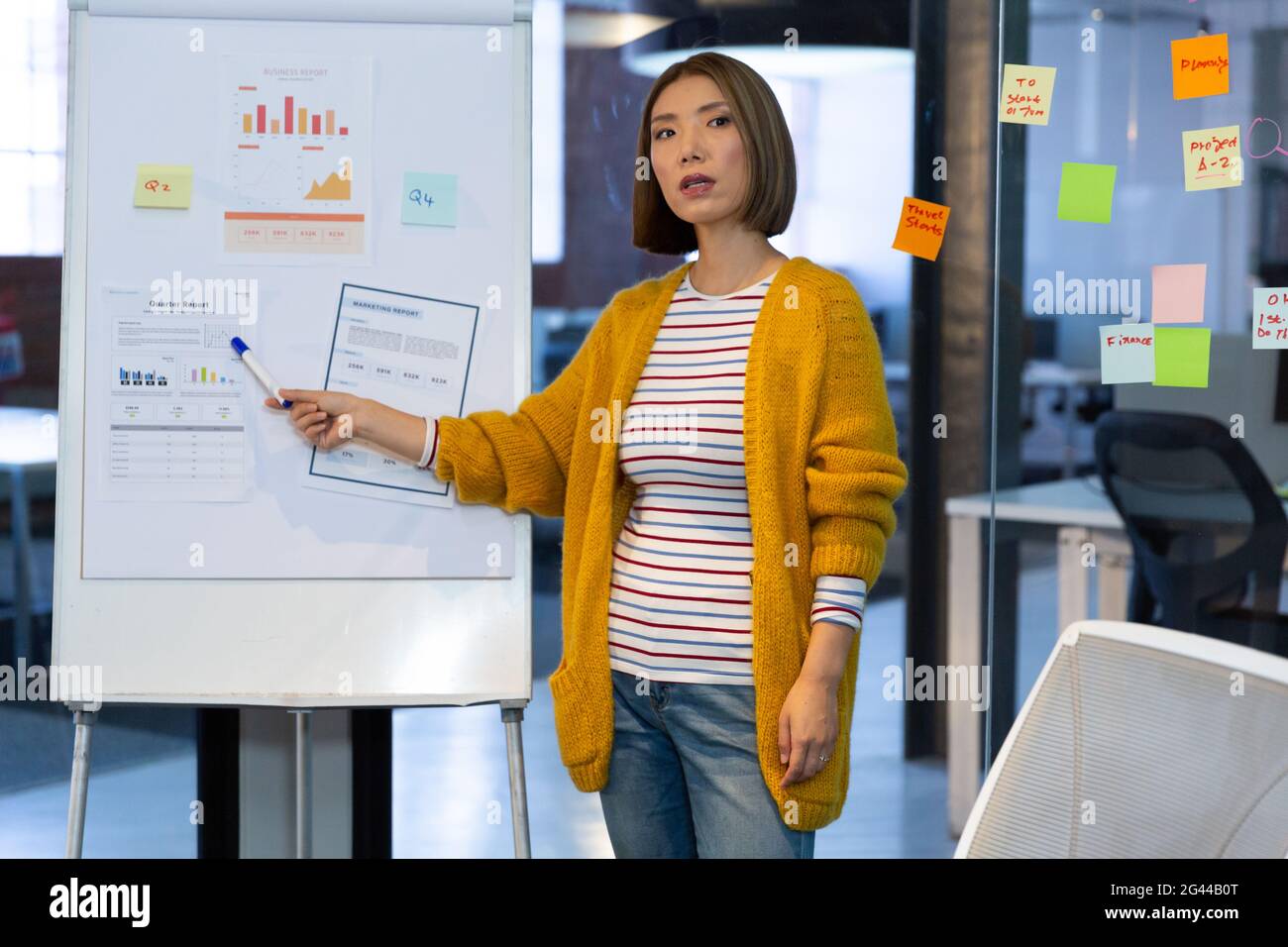 Portrait of asian businesswoman standing in front of whiteboard ...