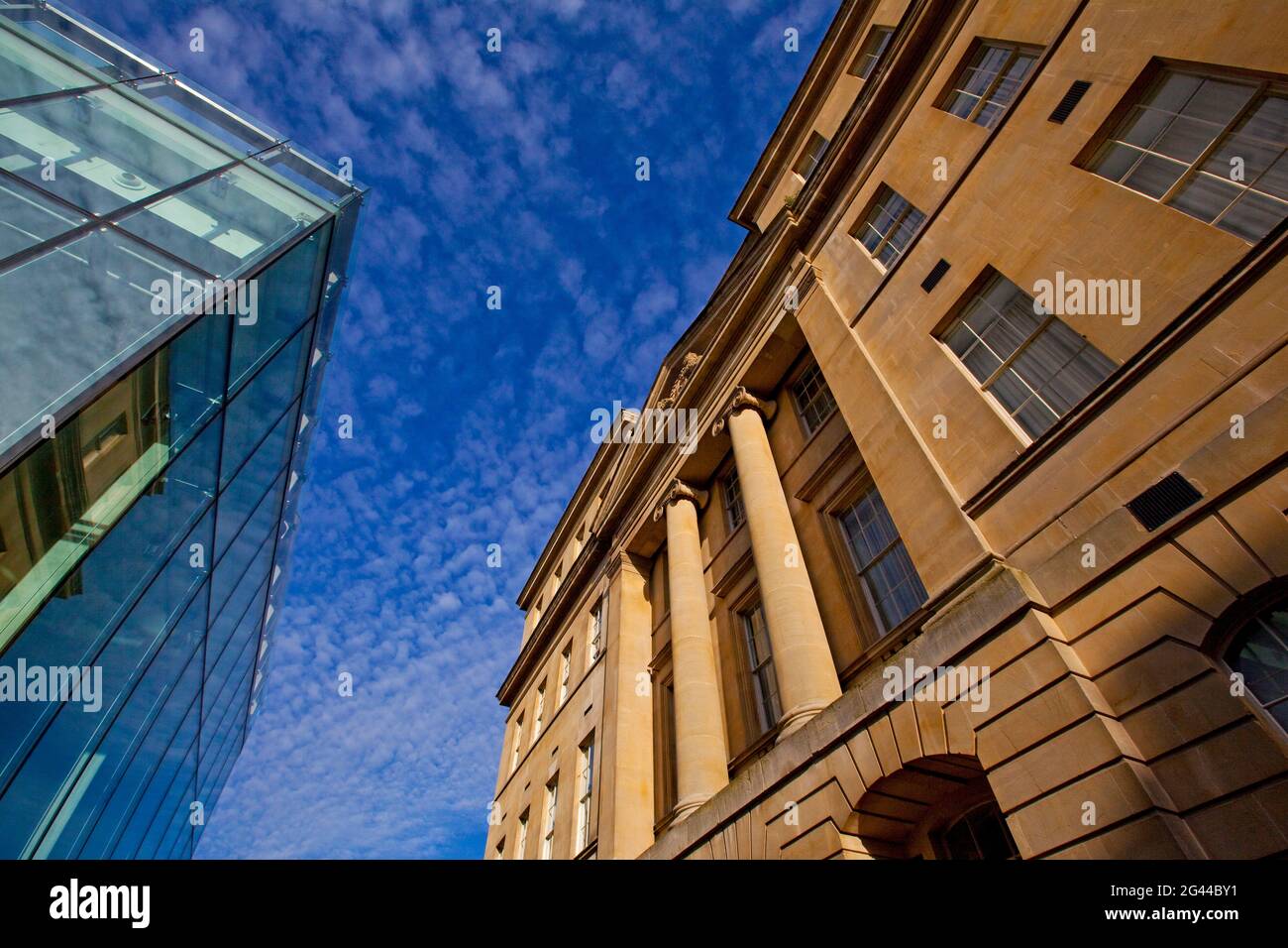 Juxtaposition of a modern glass building and a classic, columned ...