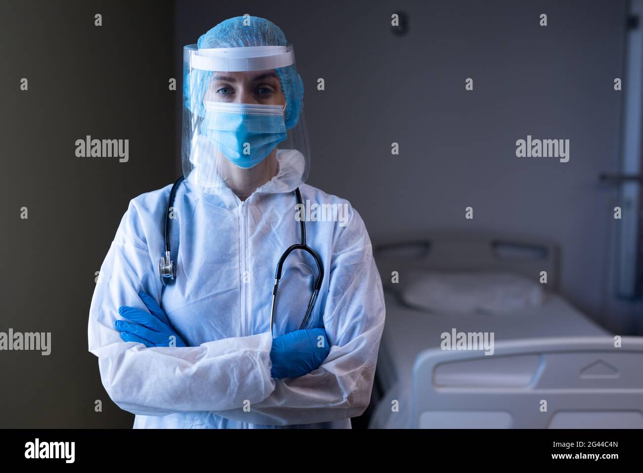 Caucasian female doctor in hospital wearing ppe suit, face mask, face ...
