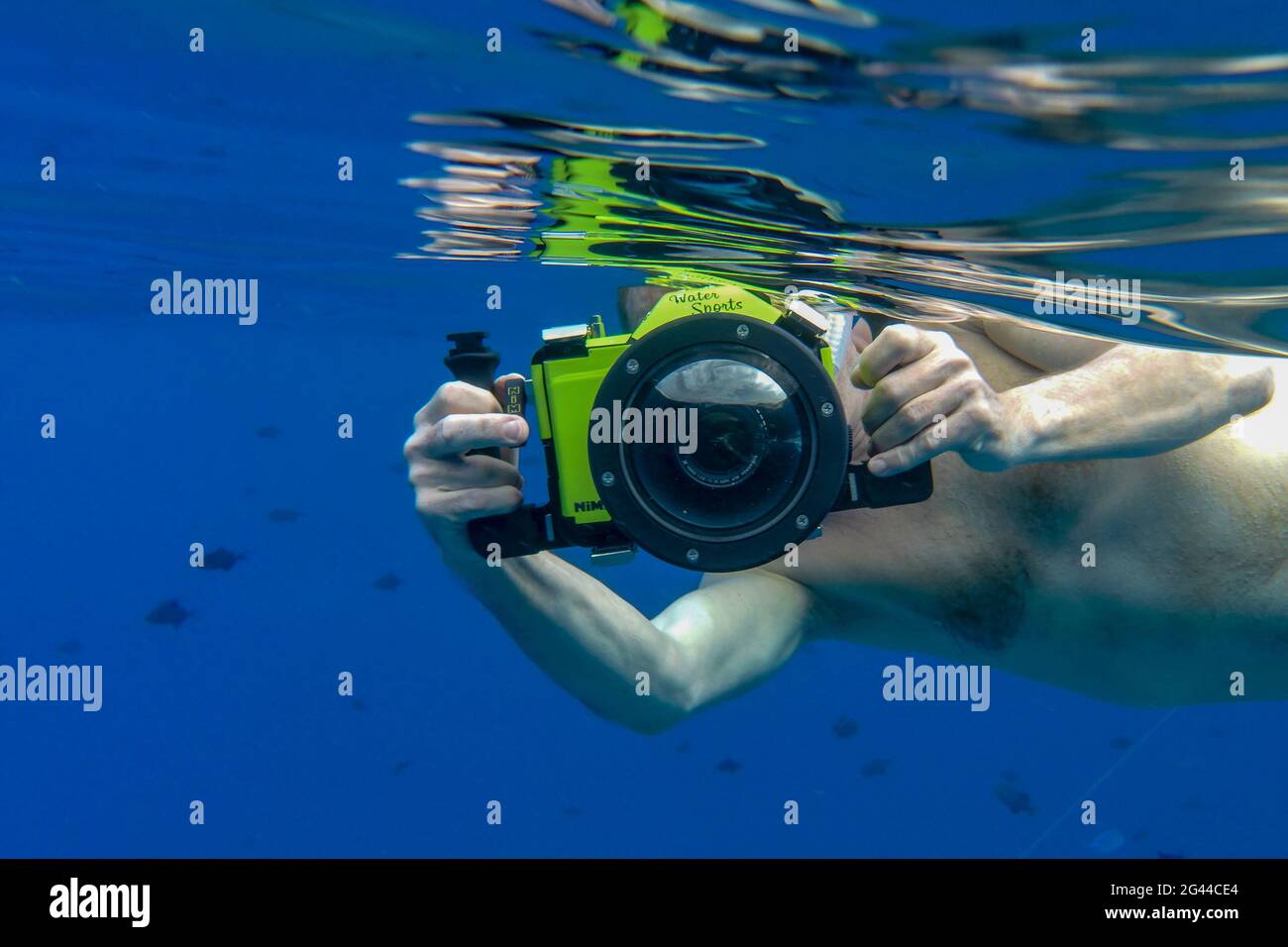 Underwater shot of man with Panasonic Lumix camera with underwater ...