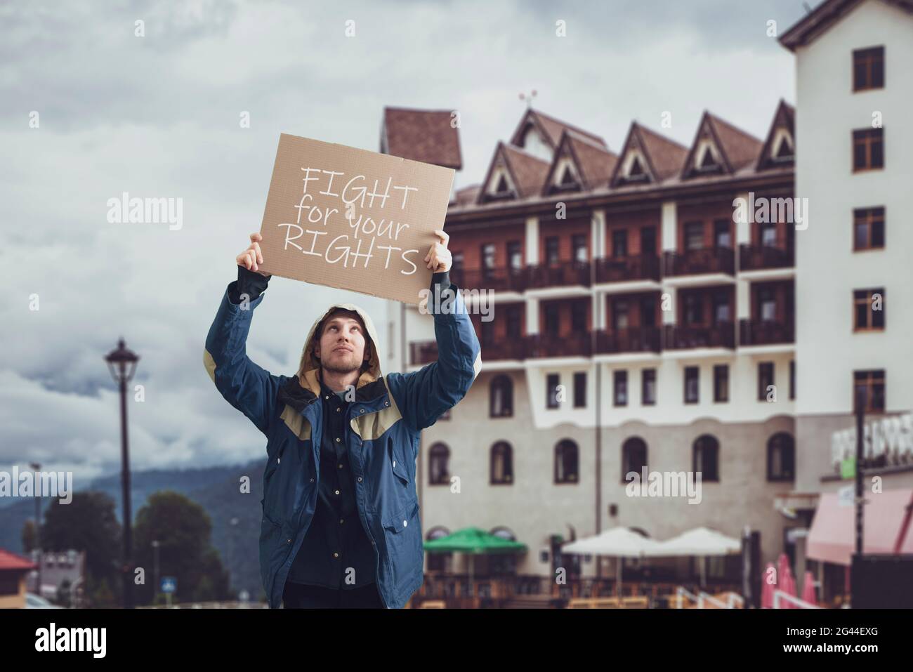 male young activist with cardboard, solo protest, political gesture ...