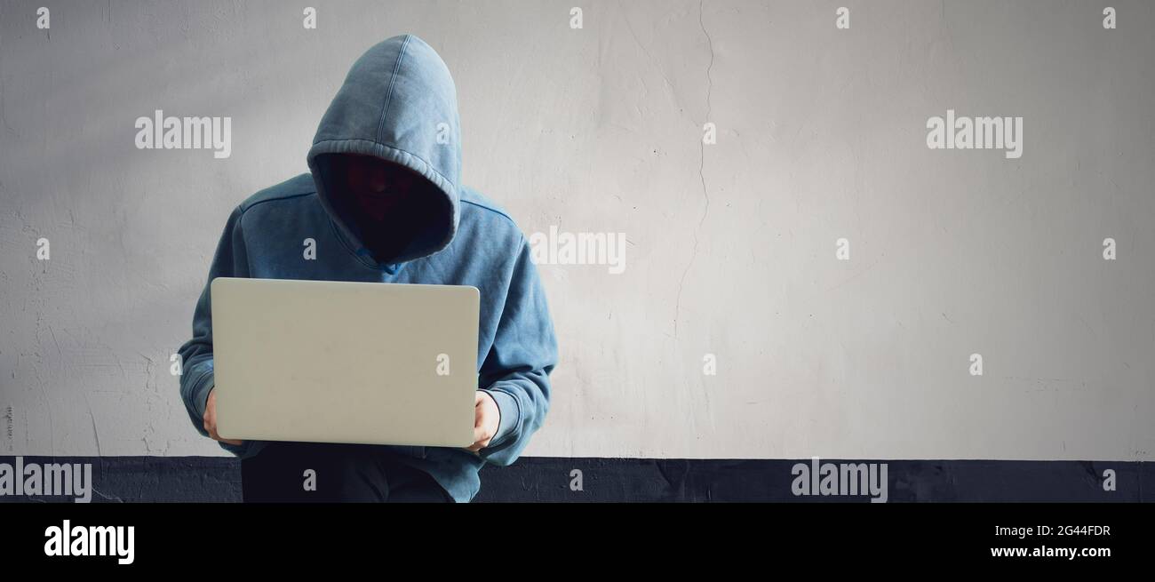 anonymous hacker person in the hood with computer, digital information ...