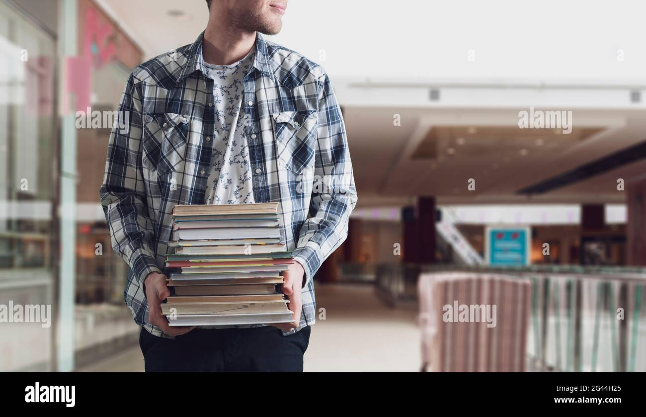 student holding stack of books, carry heavy paper textbooks, motivation ...
