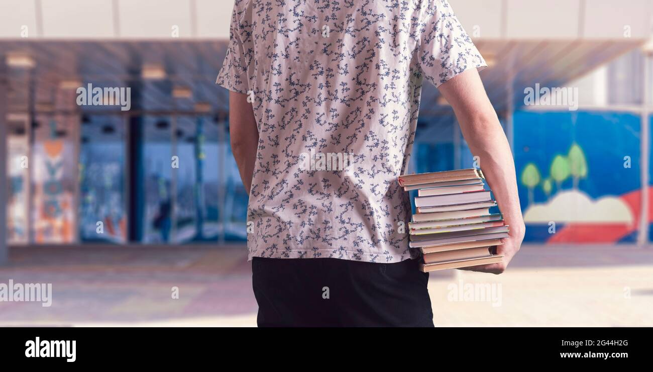 student holding stack of books, carry heavy paper textbooks, motivation ...
