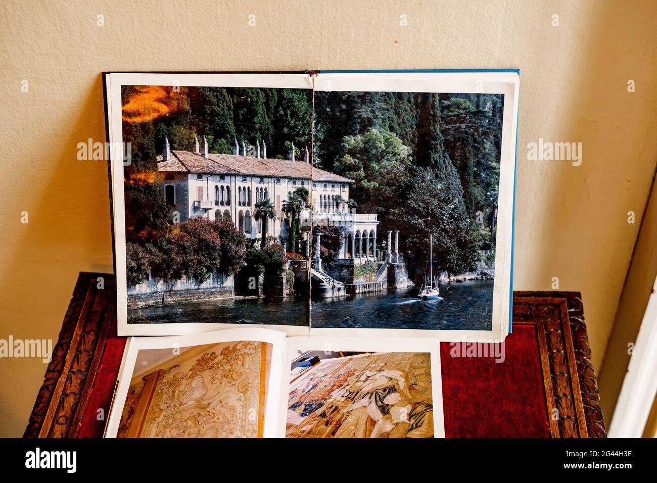Open book with a photo of a beautiful building stands on the table ...