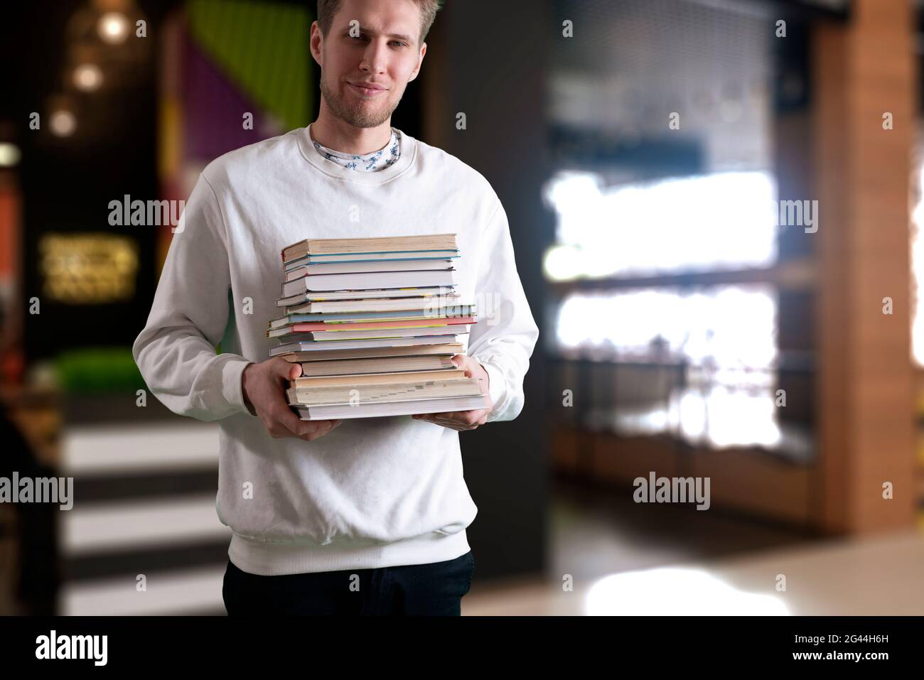 student holding stack of books, carry heavy paper textbooks, motivation ...