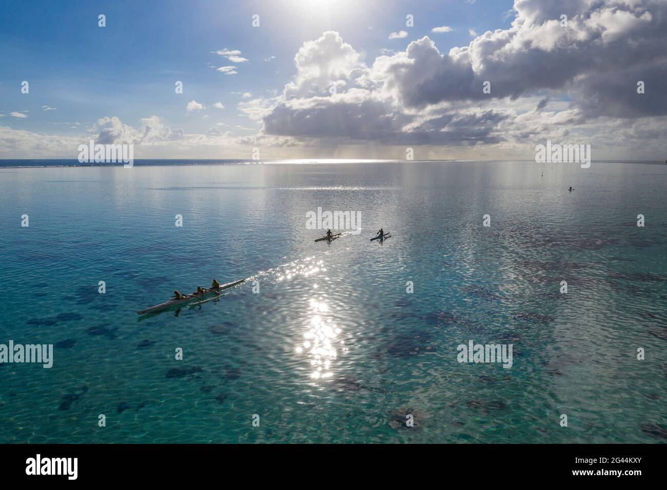 Aerial view of outrigger racing canoes in the Moorea Lagoon, Avamotu ...