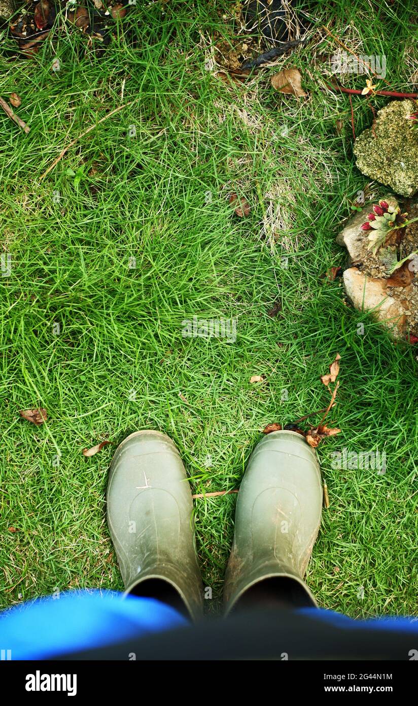 perspective view of person wearing rubber boots in the grass Stock ...