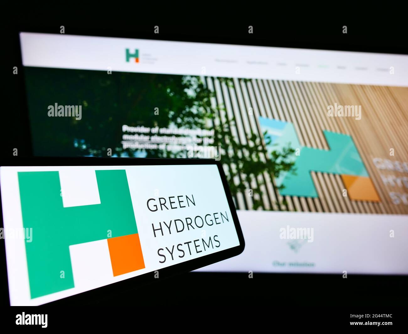 Mobile phone with logo of Danish energy company Green Hydrogen Systems ...