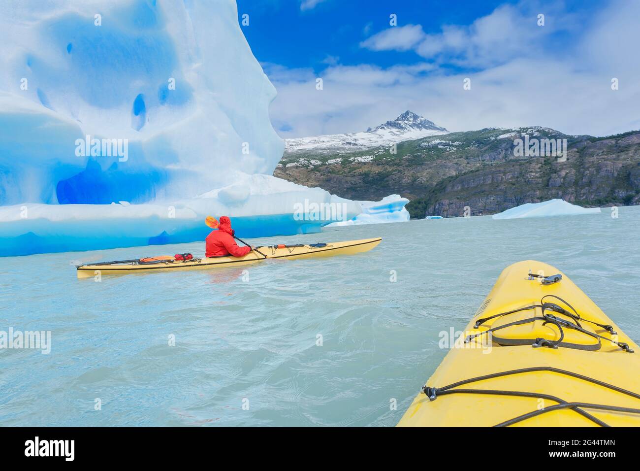 Kayaker paddling near icebergs, Torres del Paine National Park, Chile ...
