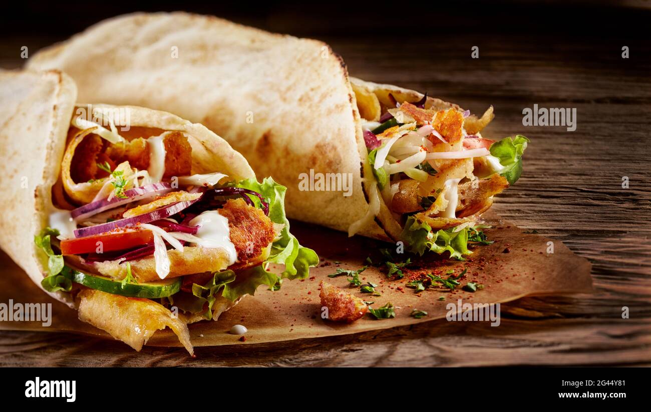 Yummy doner kebab with chicken meat and fresh vegetables placed on ...