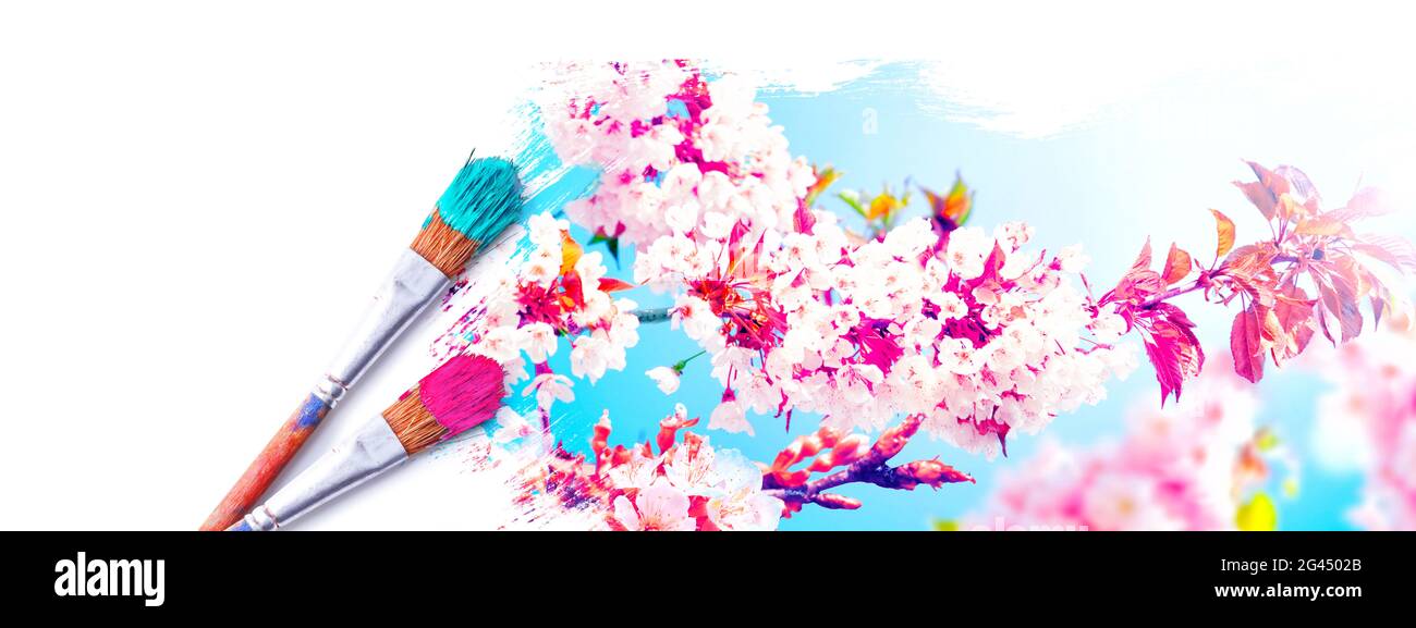 Painting the spring landscape. Brush with blue paint over sky and green ...