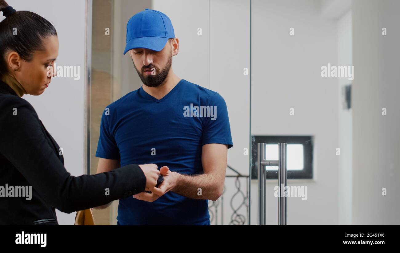 Delivery guy holding POS terminal service delivering takeaway food meal ...