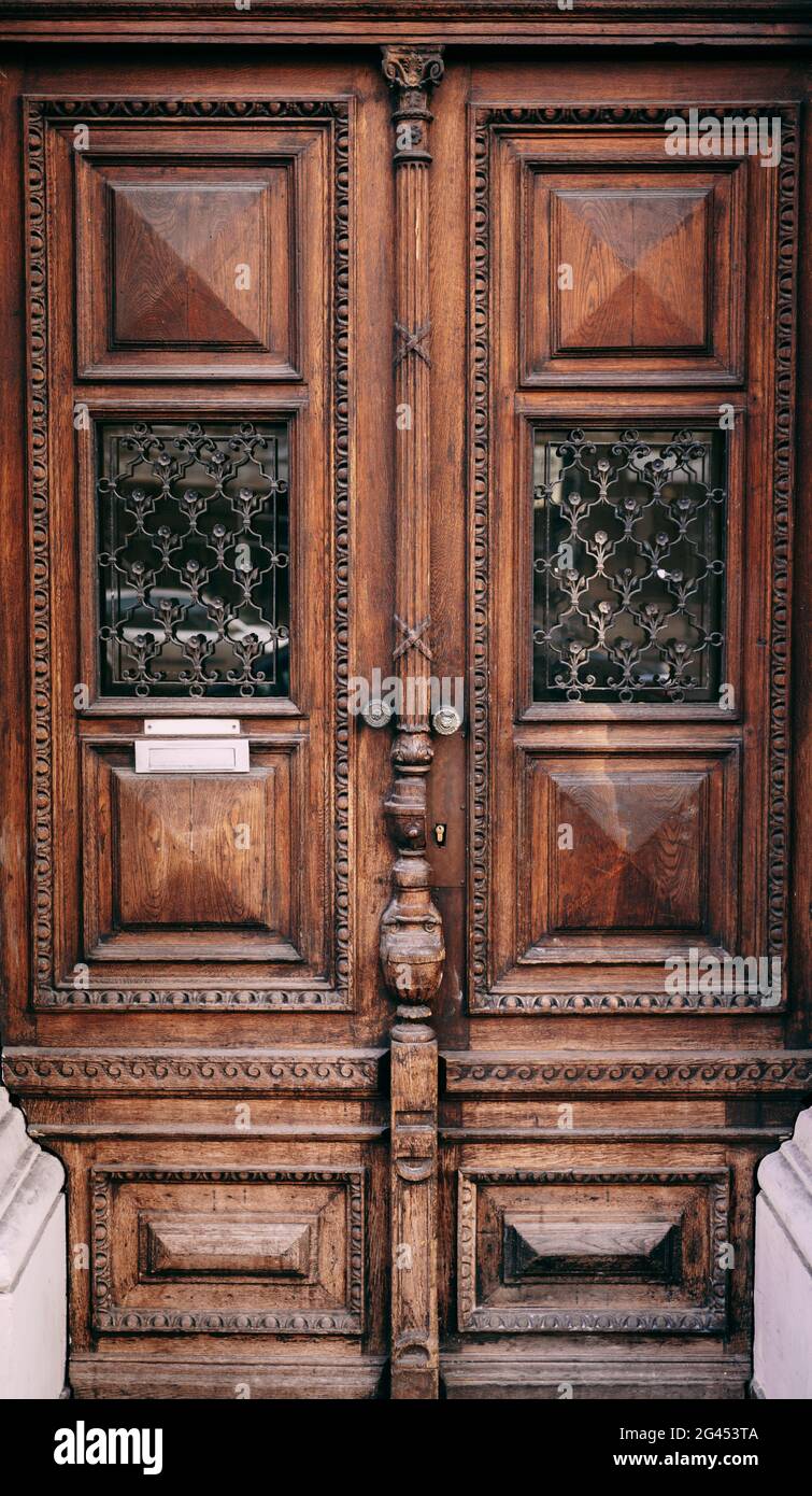 Brown wooden doors with barred windows and carvings Stock Photo - Alamy