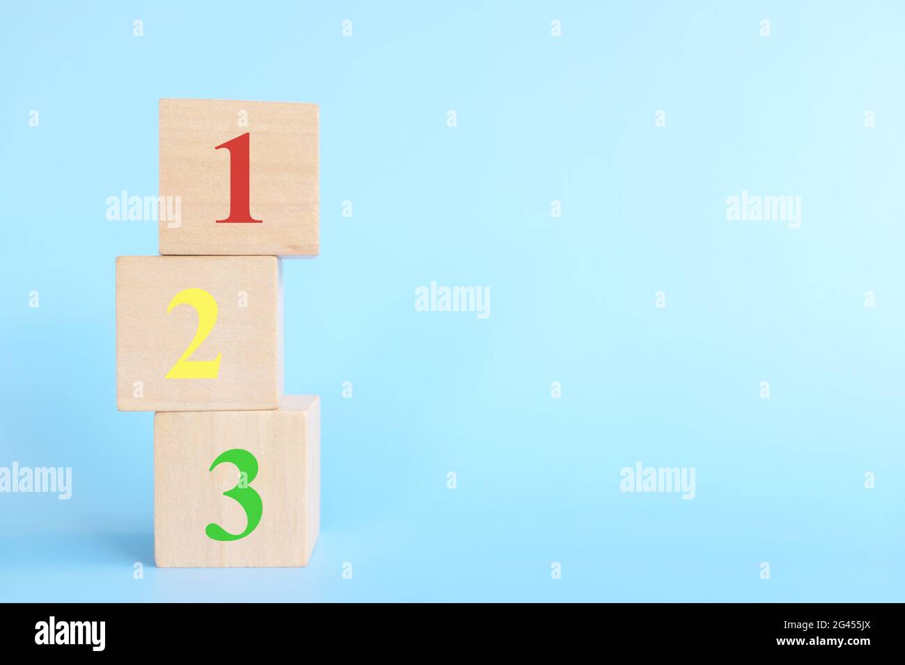 Colorful 123 numbers on wooden blocks in blue background with copy ...