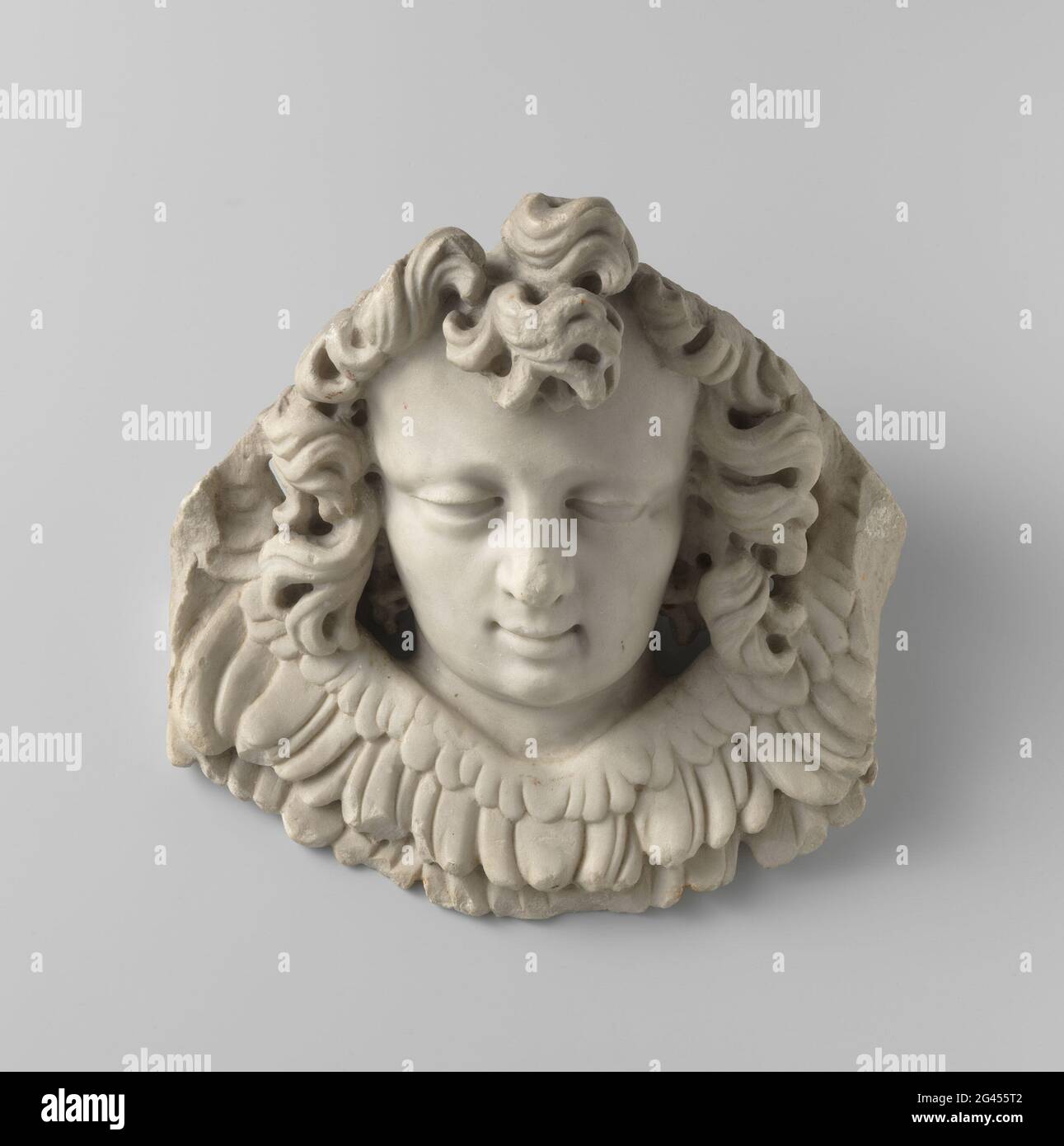 Angel head. White marble angel head with strong curly hair and feathers ...