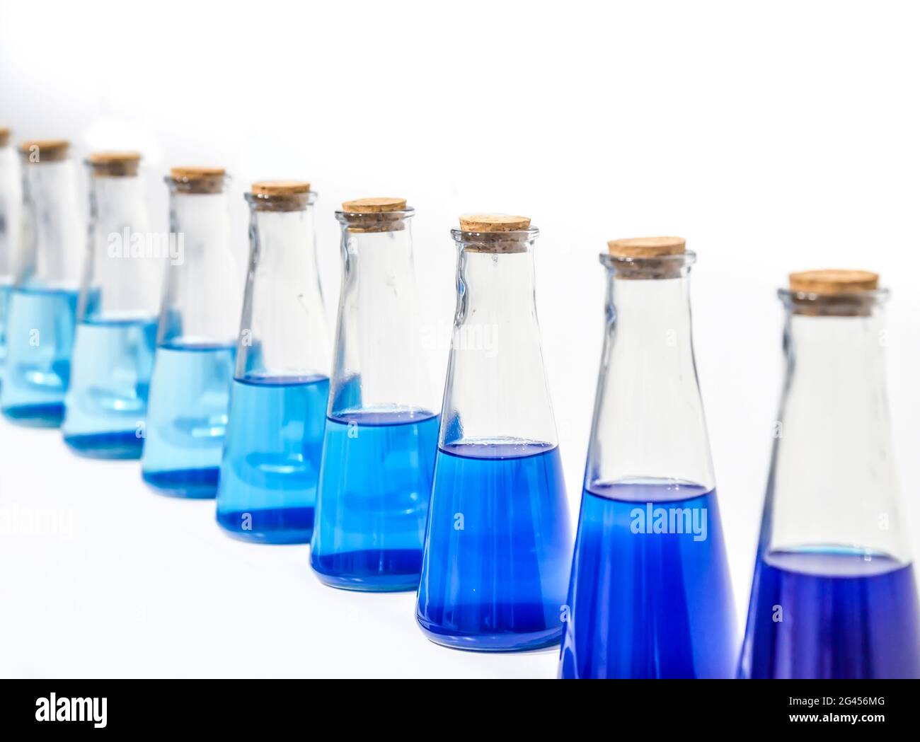 A glass bottle with blue liquid Stock Photo - Alamy