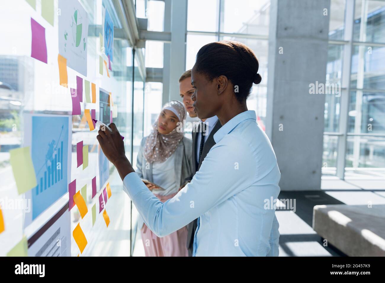 Business people discussing over sticky notes in office Stock Photo - Alamy