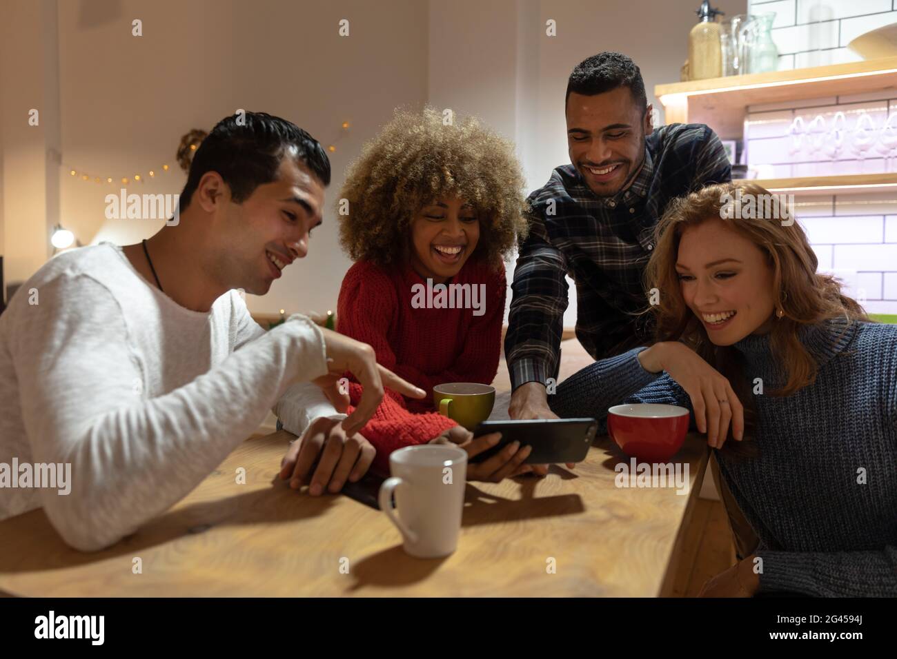 Millennial adult friends socialising together at home Stock Photo - Alamy