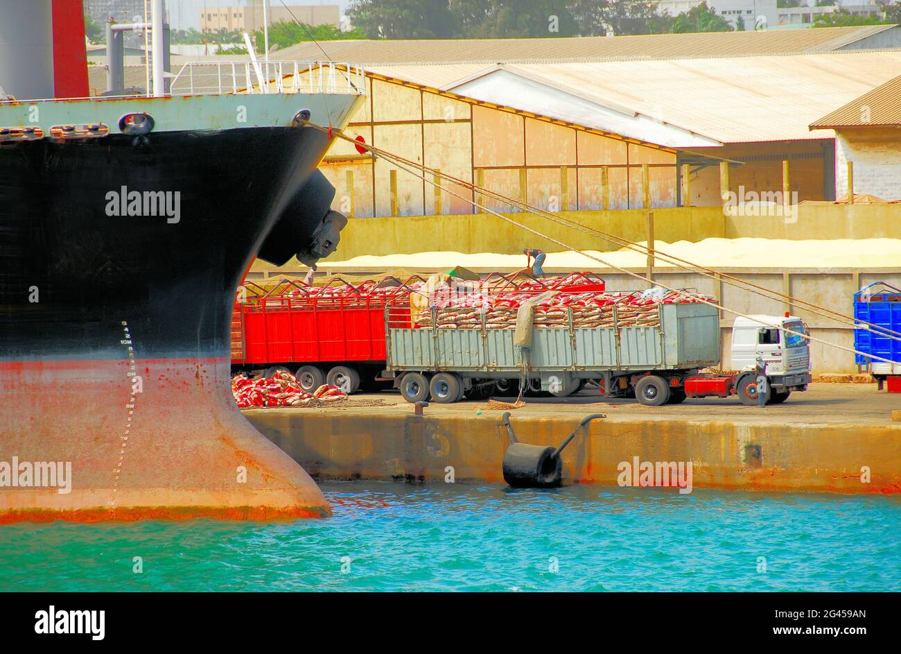 At the Port of Cotonou, Benin, West Africa, a ships imports are being ...