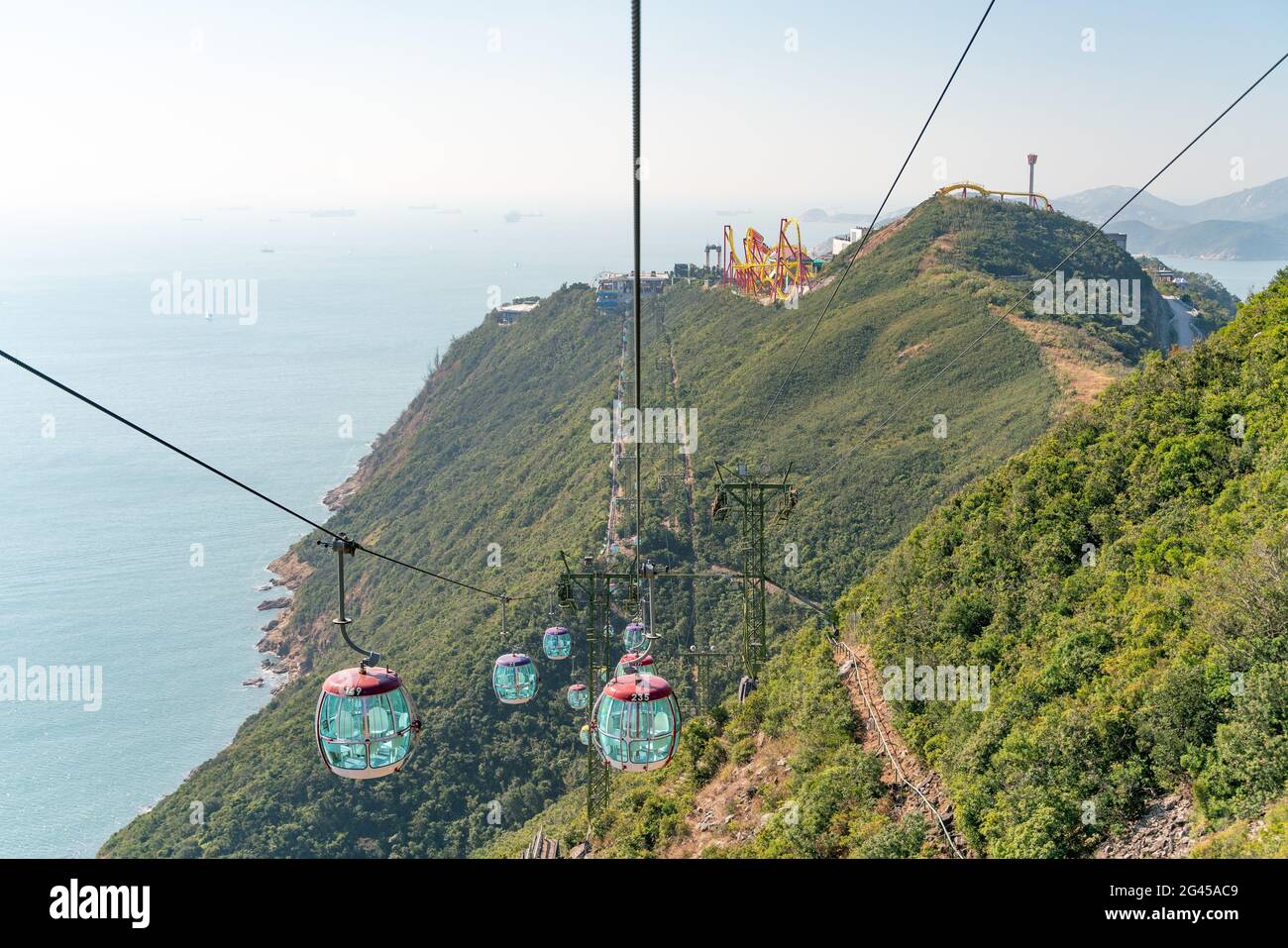 The sunny view of cable car and theme park near to ocean Stock Photo ...