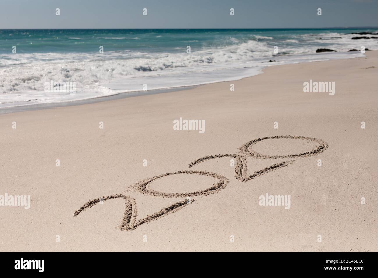 Beach holiday with 2020 in the sand Stock Photo - Alamy