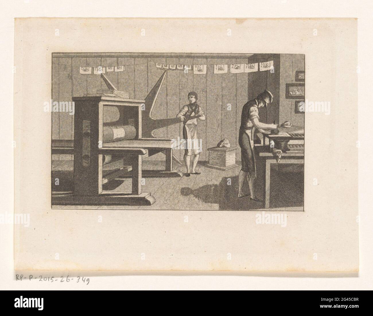 Interior of a printing company. An employee uses the printing press ...