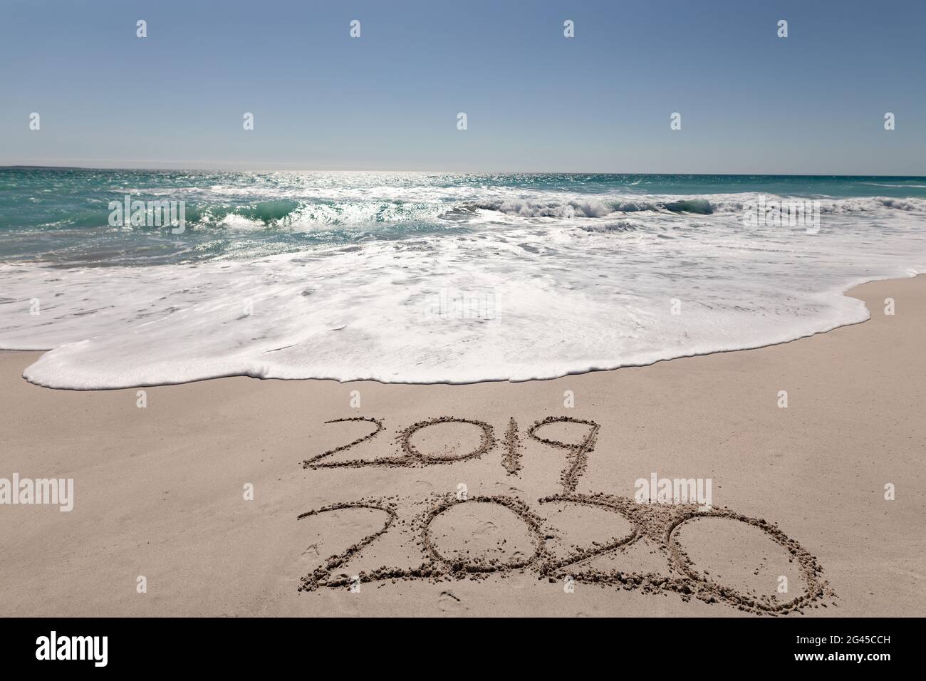 Beach holiday with 2020 in the sand Stock Photo - Alamy