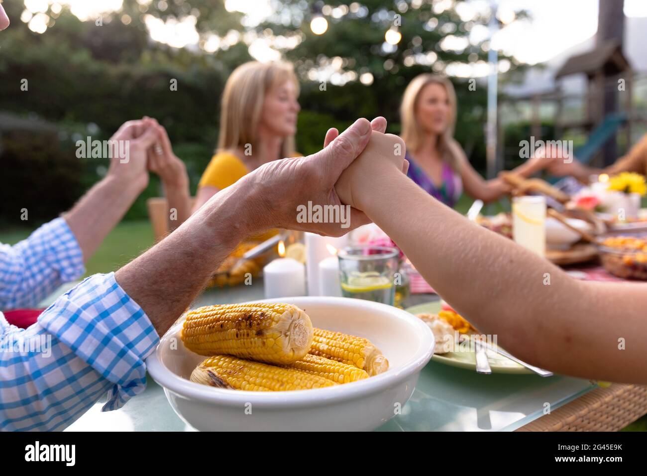 Caucasian family saying grace together before eating Stock Photo - Alamy